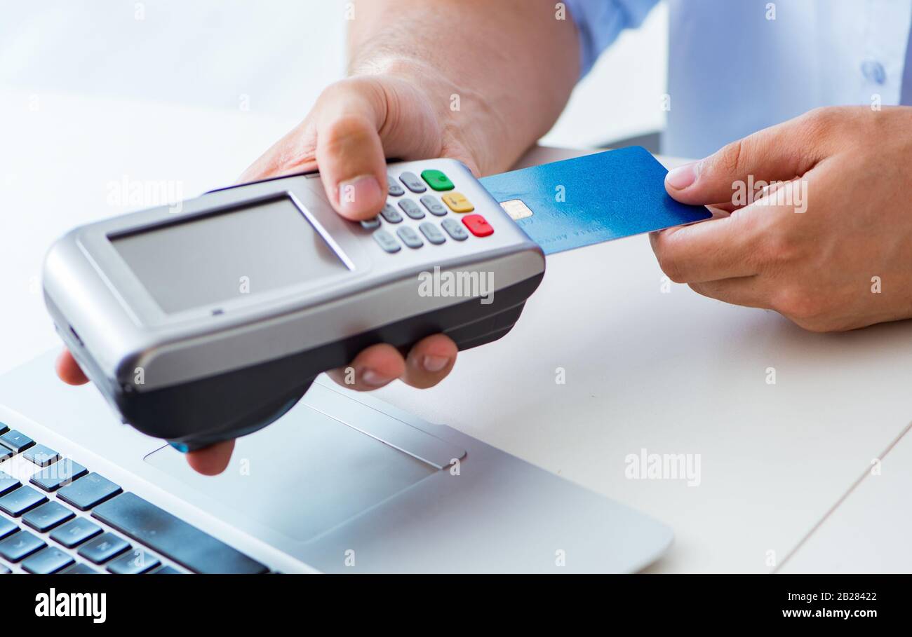 The man processing credit card transaction with pos terminal Stock ...