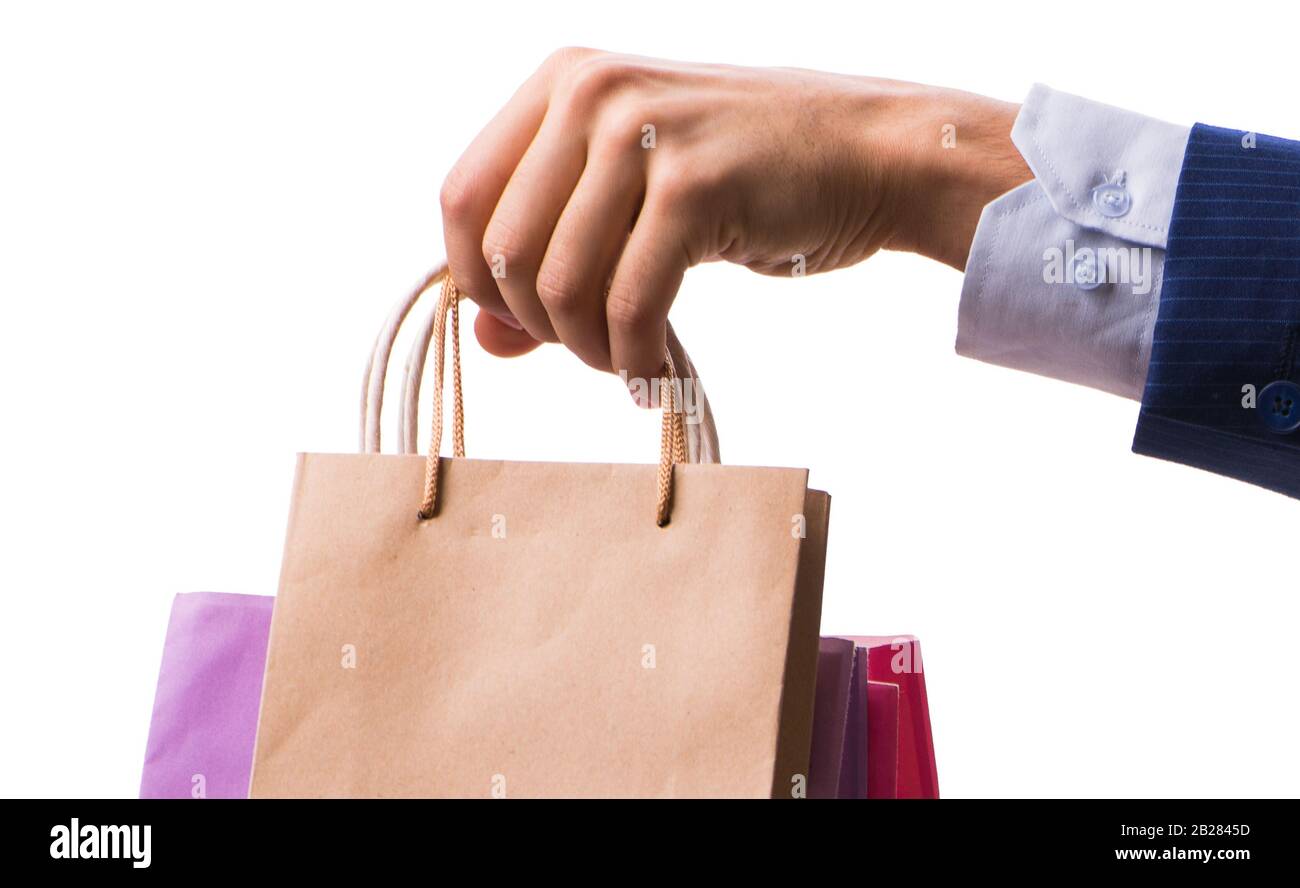 Hand holding shopping bags with christmas shopping on white background ...