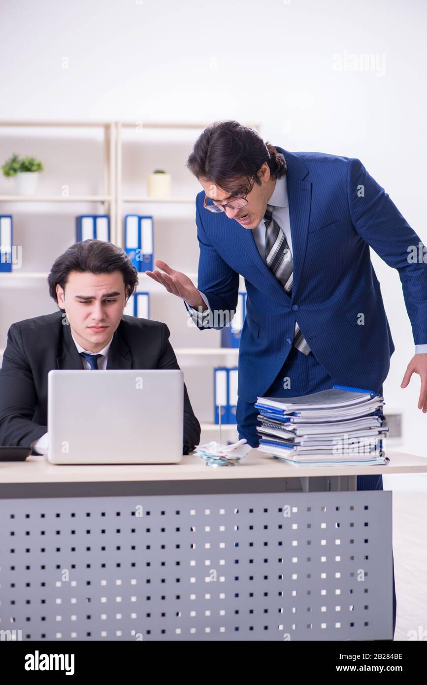 The boss and his male assistant working in the office Stock Photo - Alamy