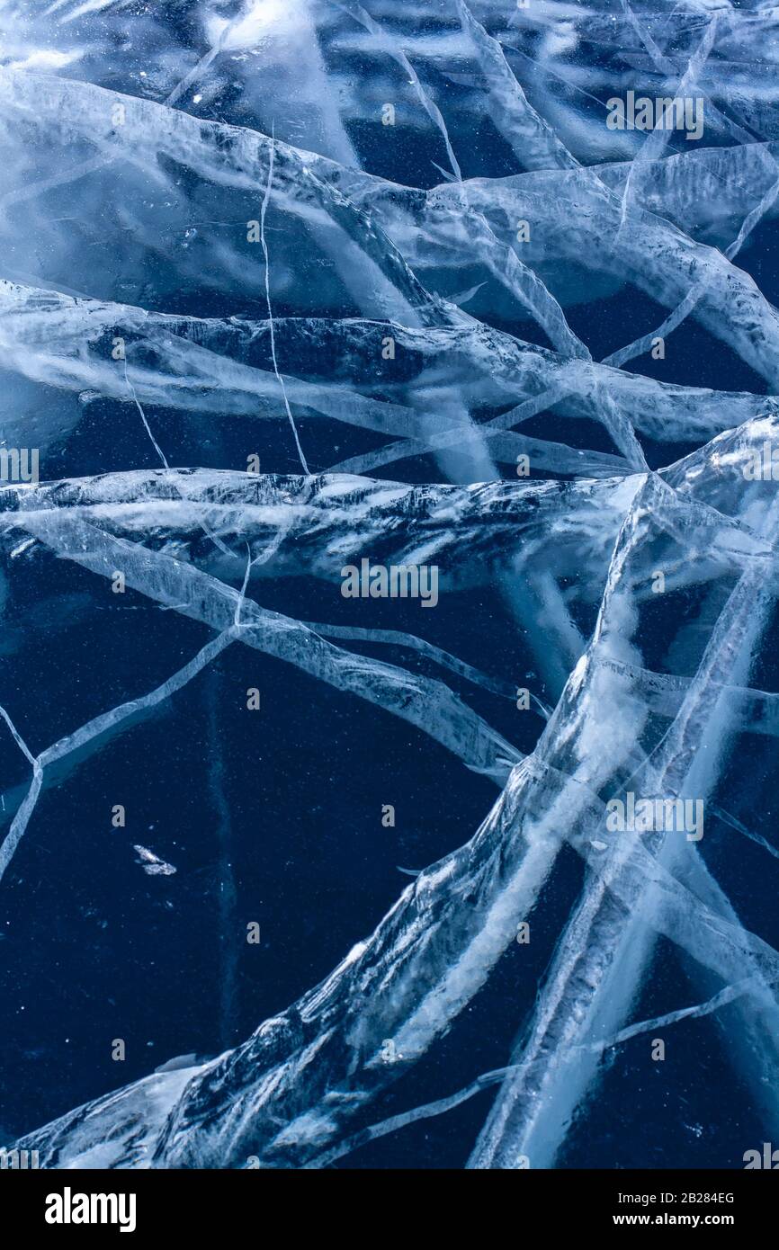 Gorgeous cracks in the ice of Lake Baikal. Blue ice with deep cracks ...