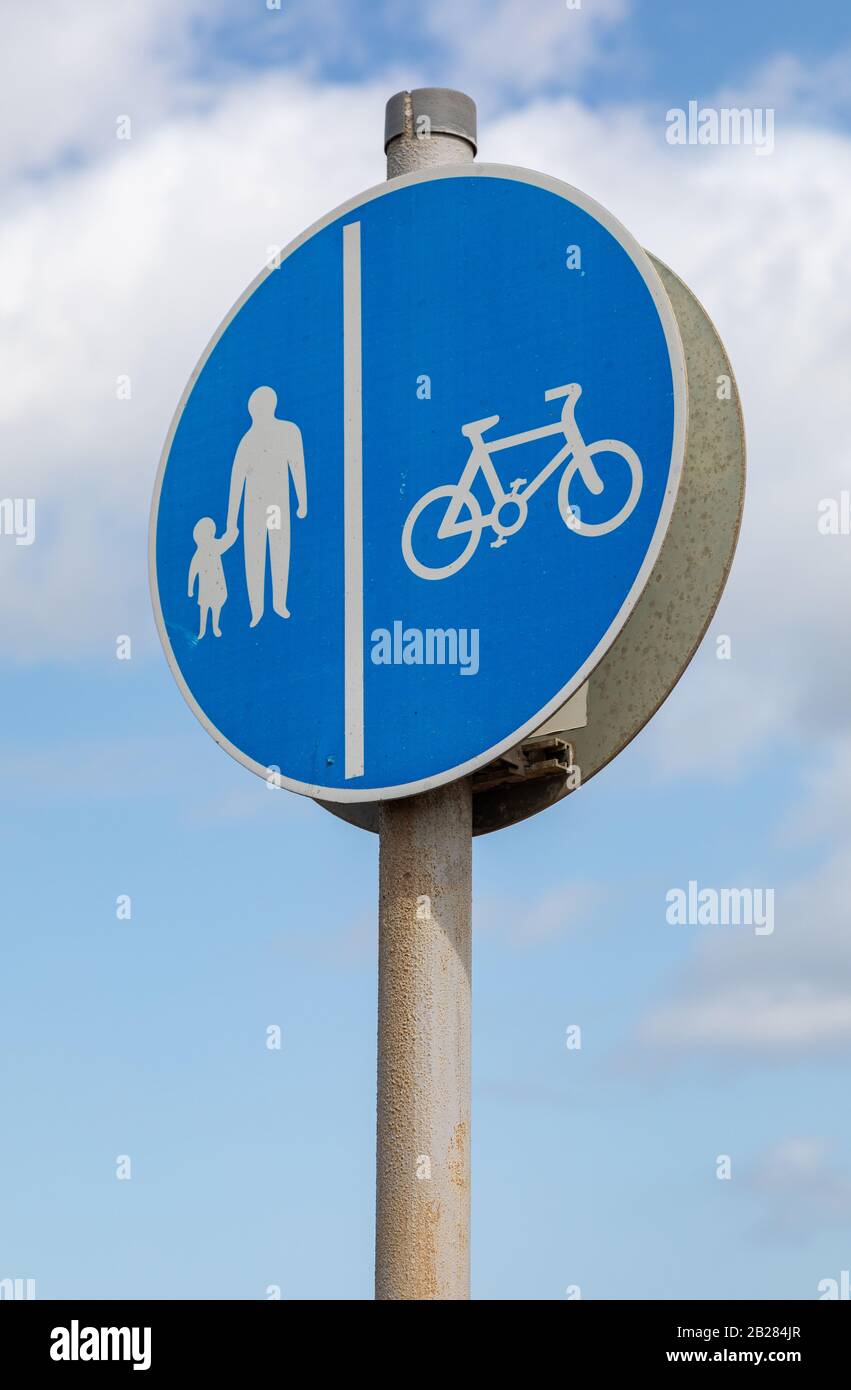 round blue sign indicating lane markings for cyclists and pedestrians ...