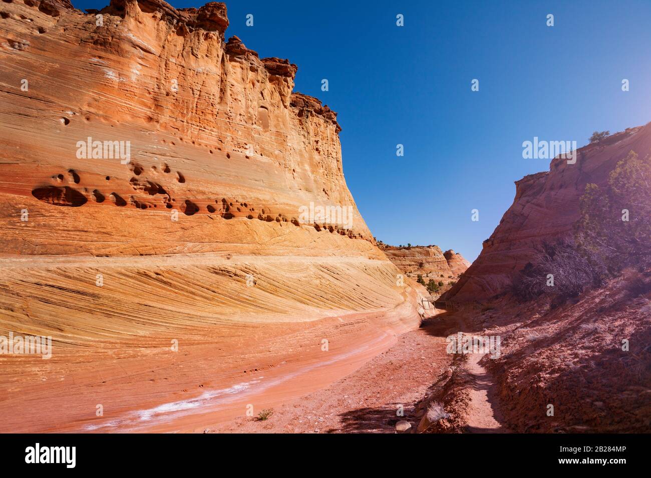 Rock canyon wall formation and dry river in sand bed in the Utah desert ...