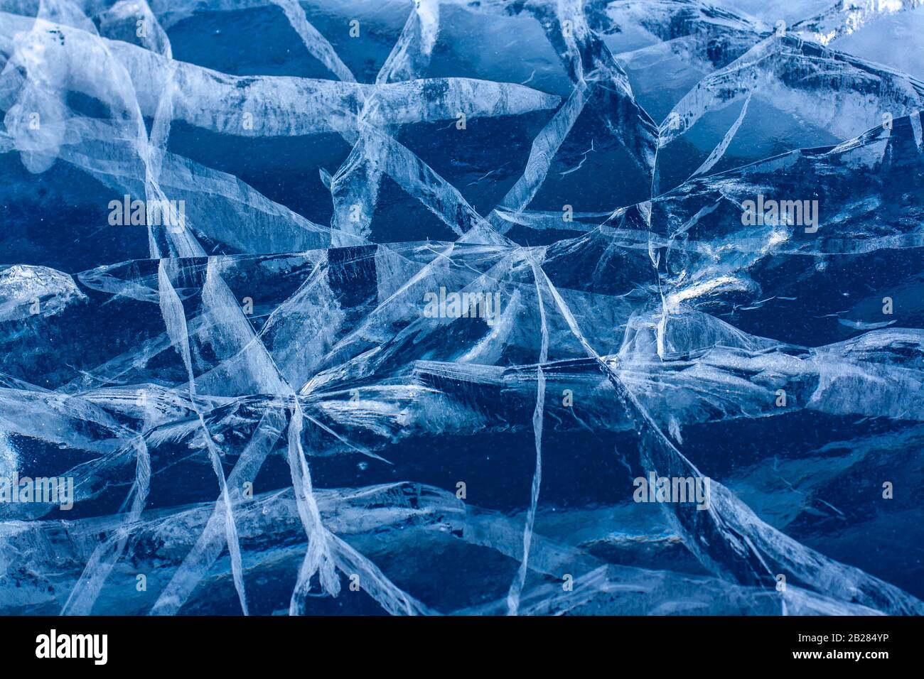 Cracked ice on Lake Baikal. Beautiful intersecting cracks in the ice ...