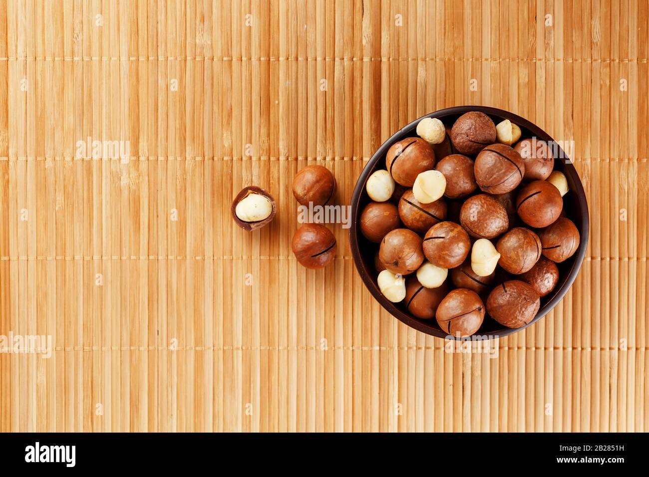 Macadamia nut on bamboo texture, concept of superfoods and healthy food ...