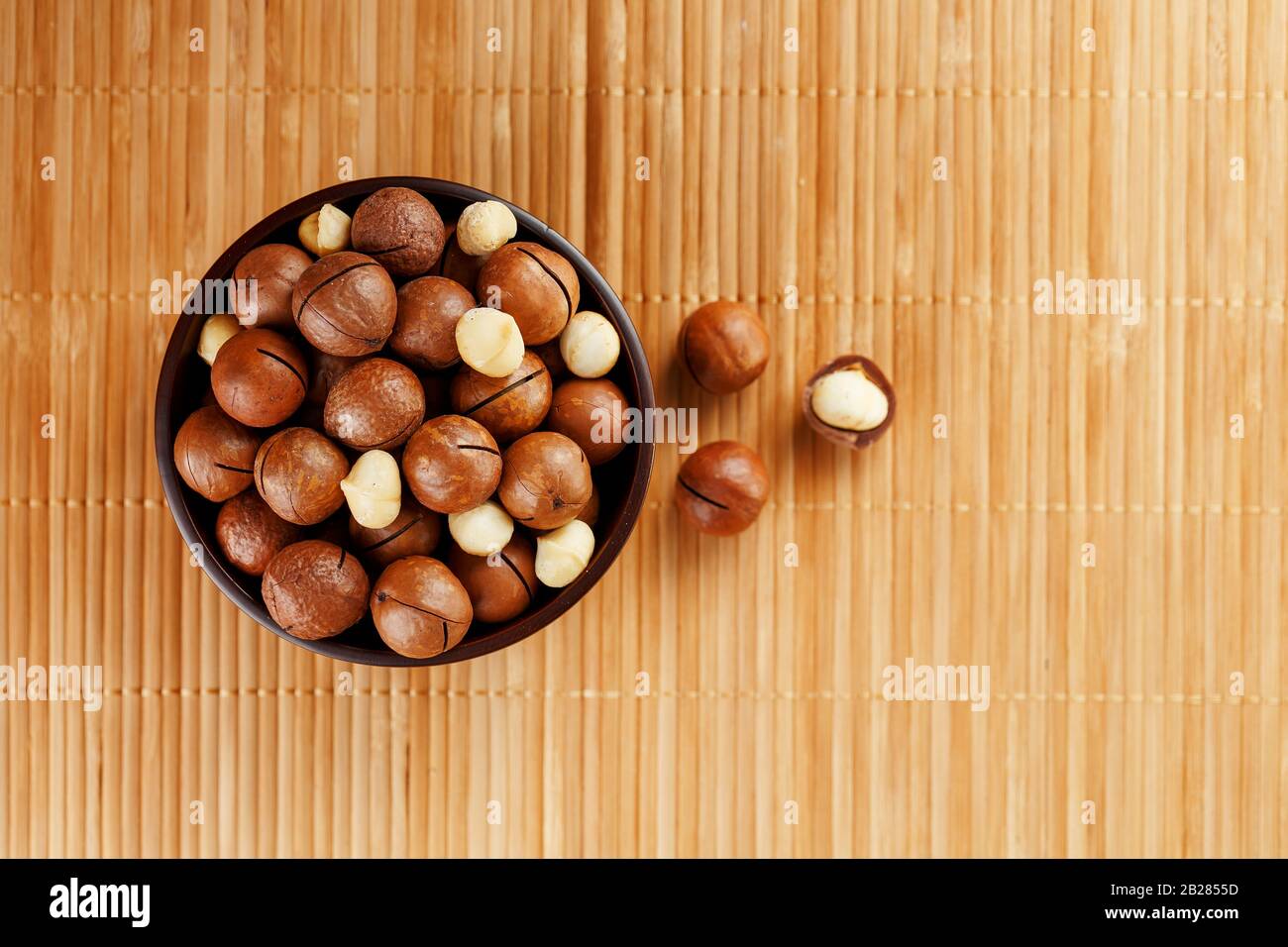 Macadamia nut on bamboo texture, concept of superfoods and healthy food ...