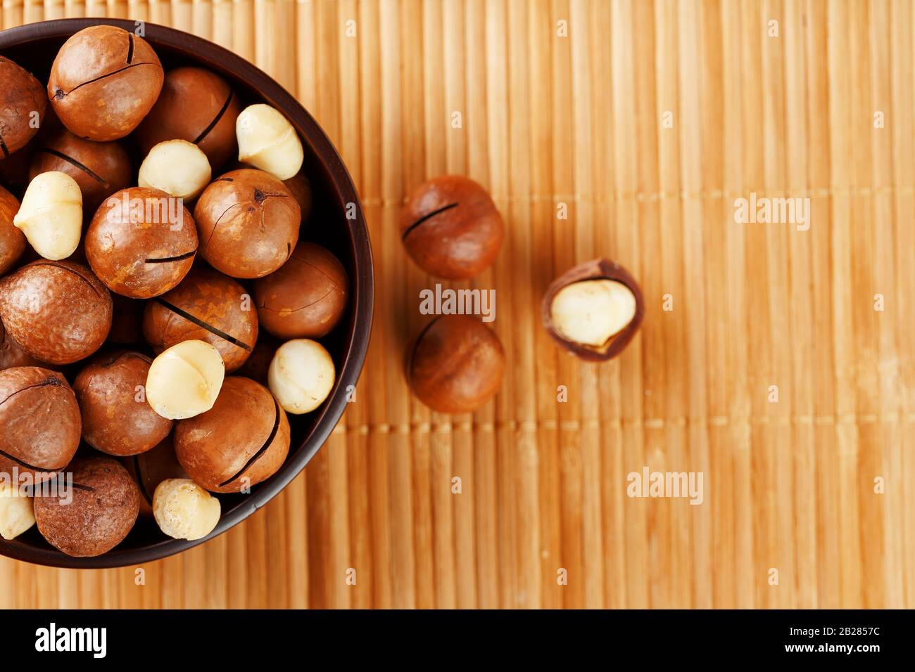 Macadamia nut on bamboo texture, concept of superfoods and healthy food ...