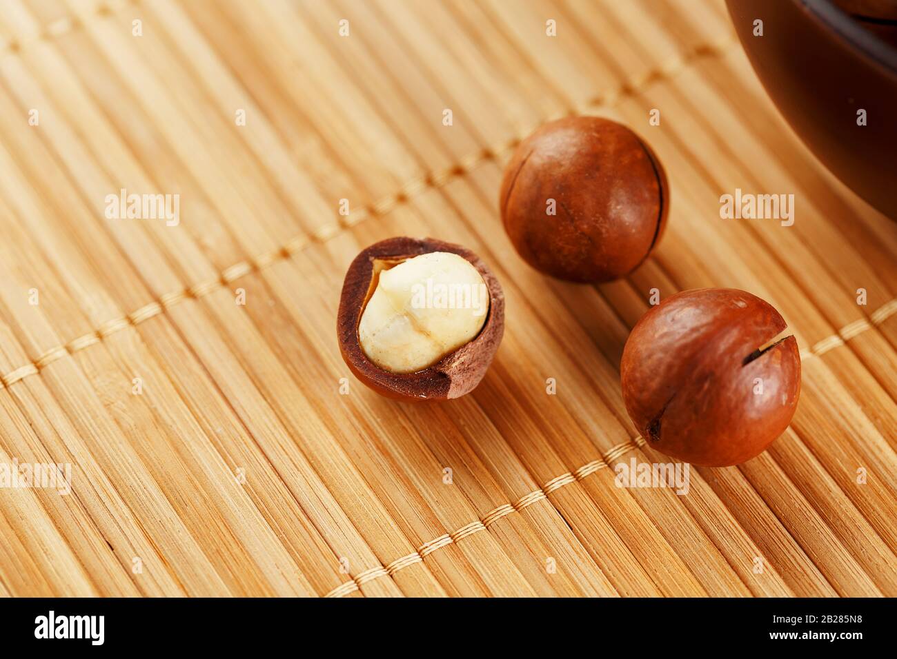 Macadamia nut on bamboo texture, concept of superfoods and healthy food ...