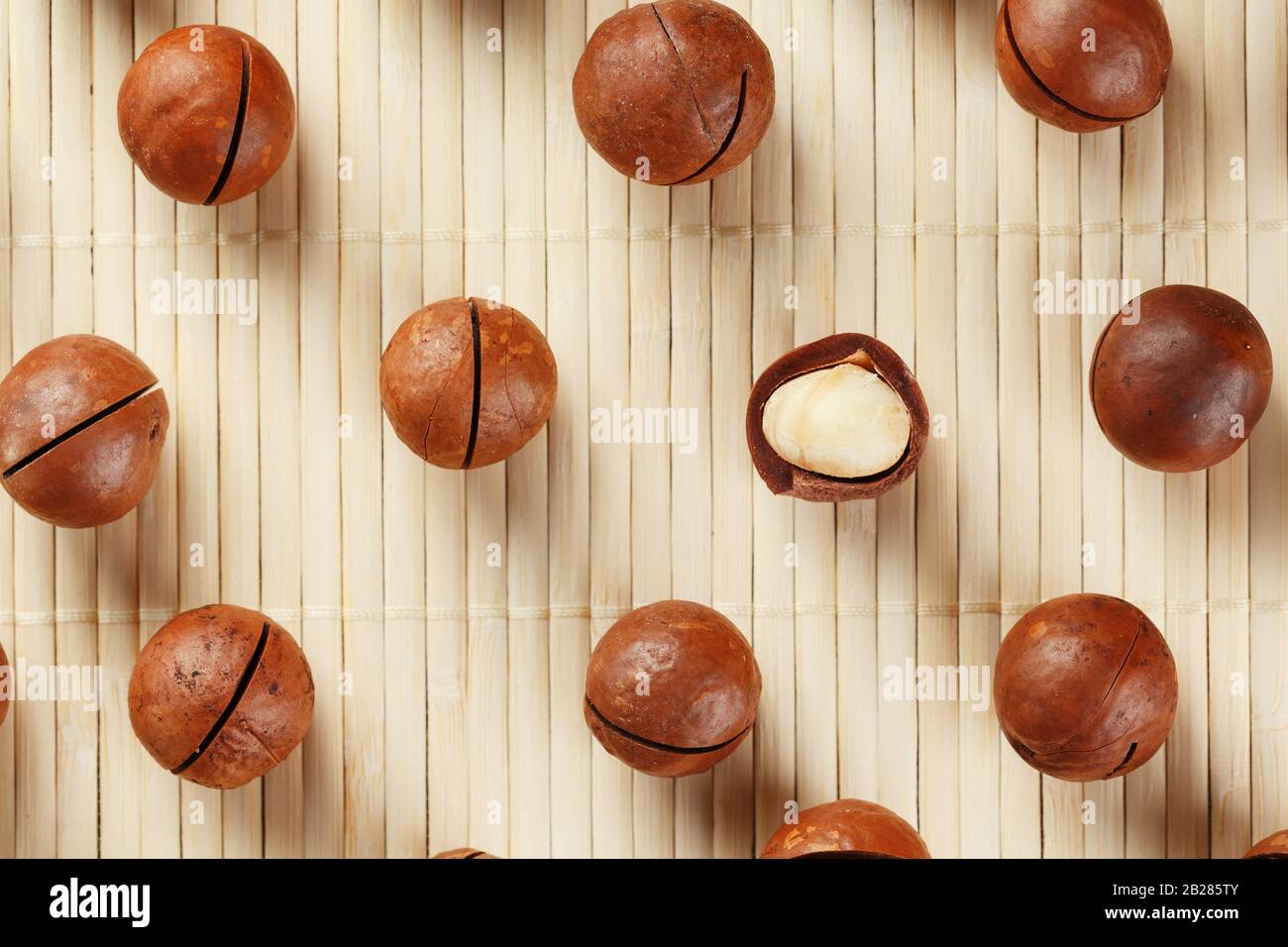 Flat composition with Australian macadamia nuts on bamboo light ...