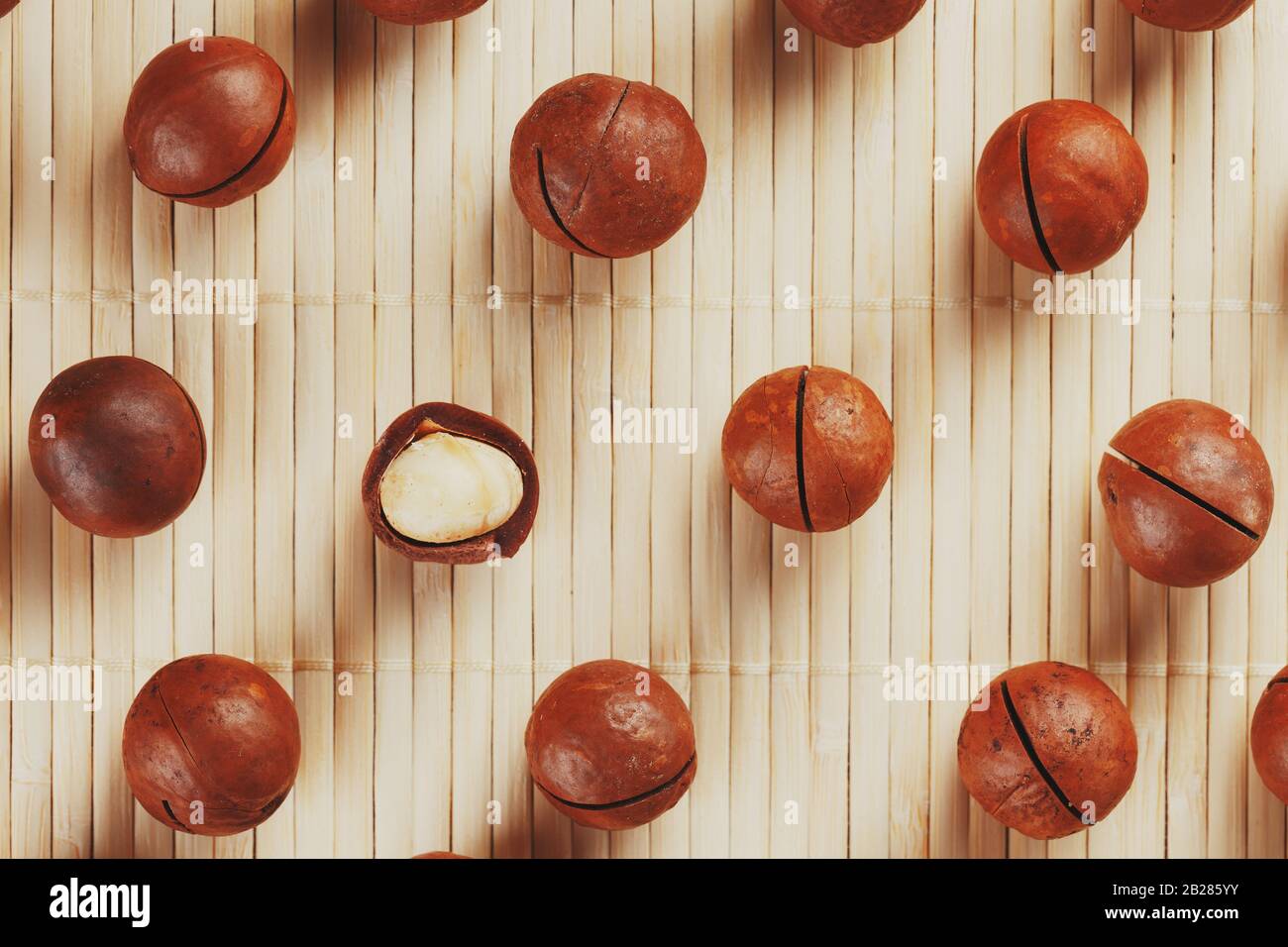 Flat composition with Australian macadamia nuts on bamboo light ...