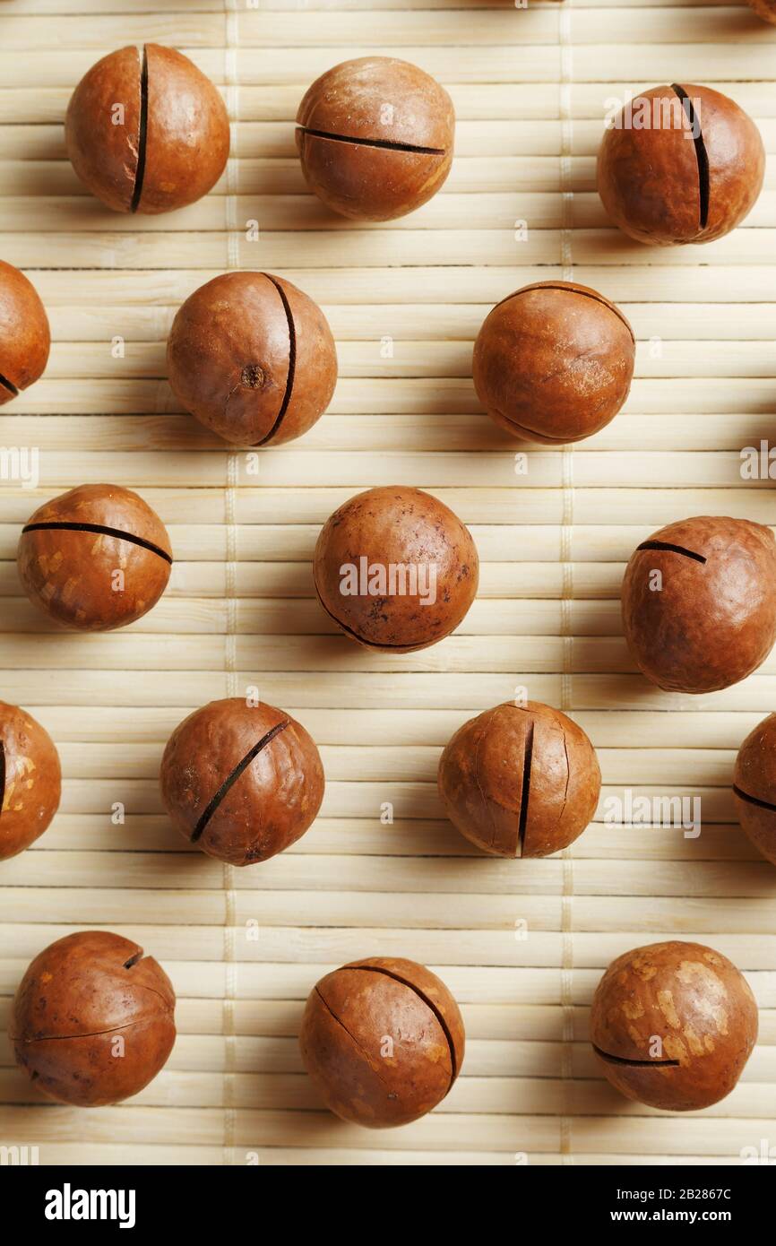 Macadamia nuts are made up of patterns on a bamboo light background ...