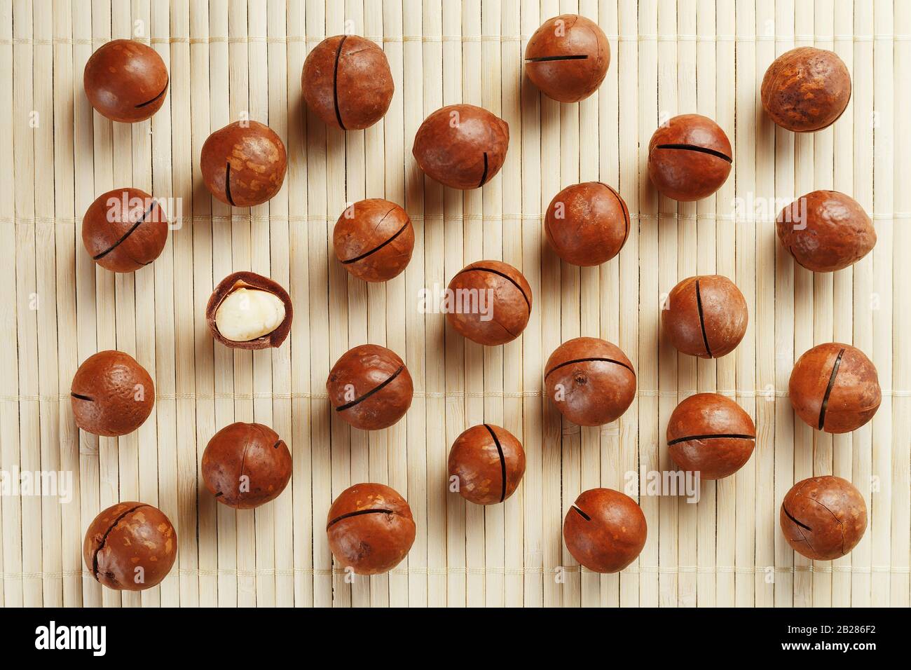 Flat composition with Australian macadamia nuts on bamboo light ...