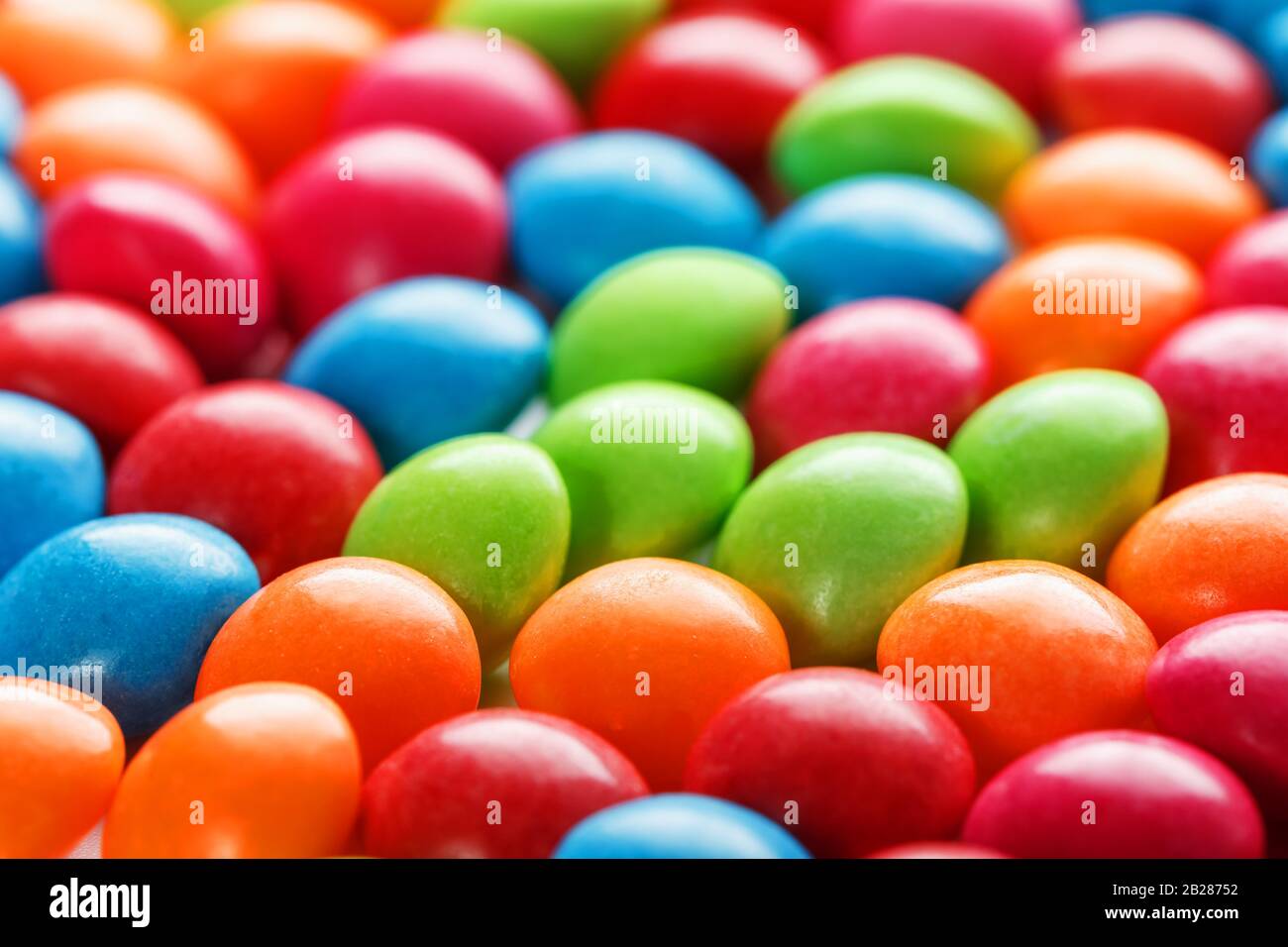 Rainbow colors of multicolored candies close-up, texture and repetition ...