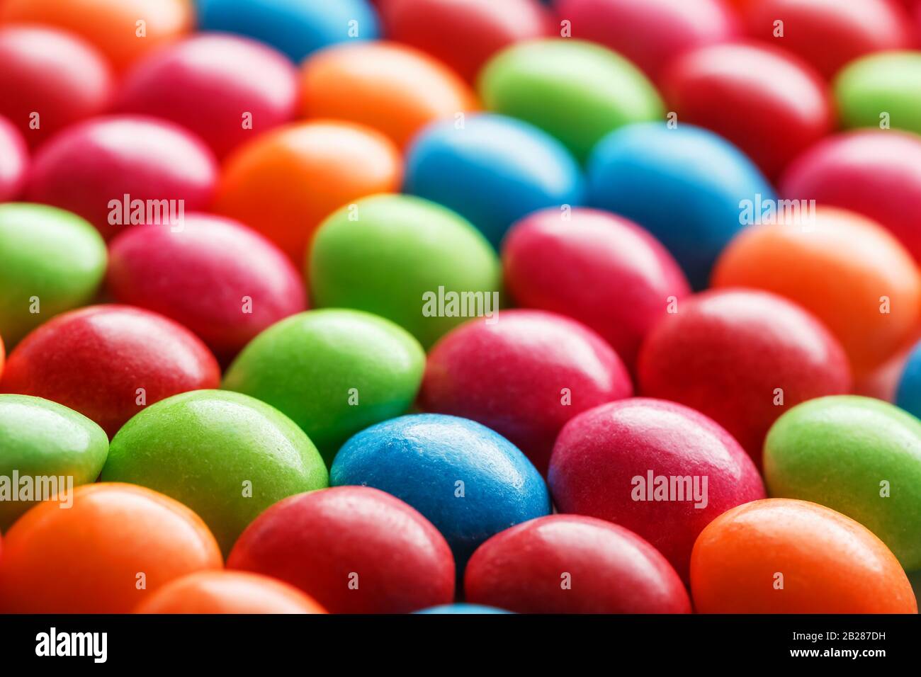 Rainbow colors of multicolored candies close-up, texture and repetition ...