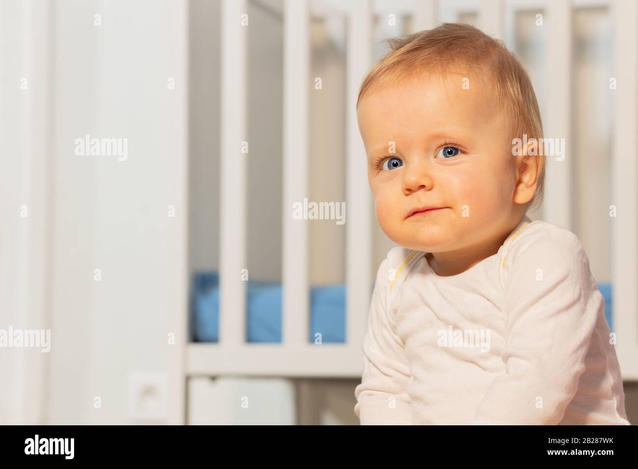 Close portrait of beautiful baby boy at toddler age with calm face ...