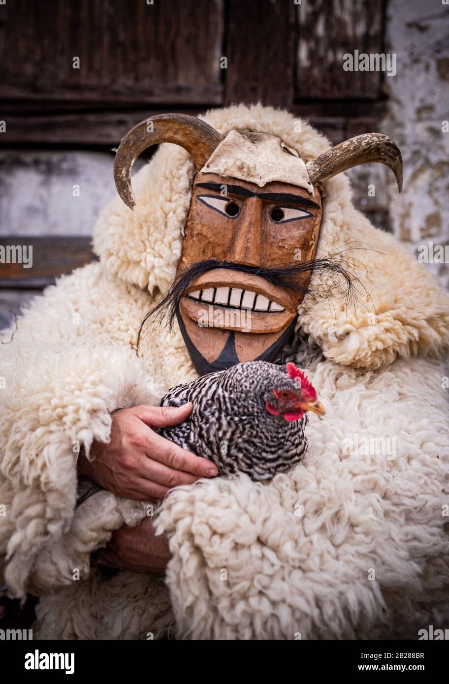 Portrait of a man dressed in "buso" costume wearing a horned mask ...