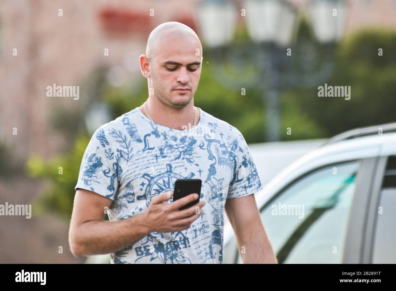 A armenian young man looking at his cellphone in Republic Square ...