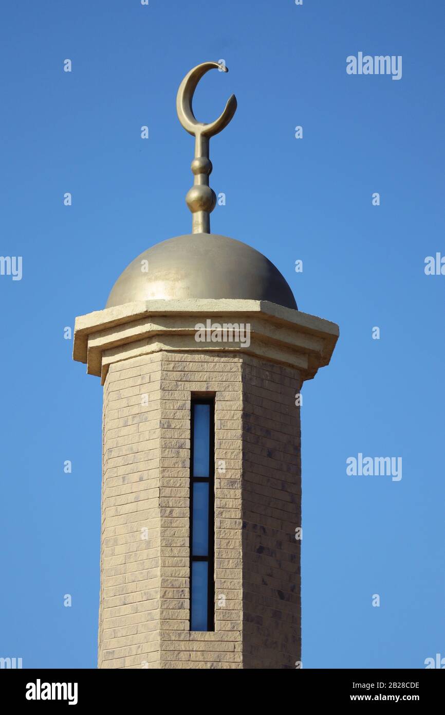 Brass or gold coloured Muslim crescent symbol on gold dome at top of ...