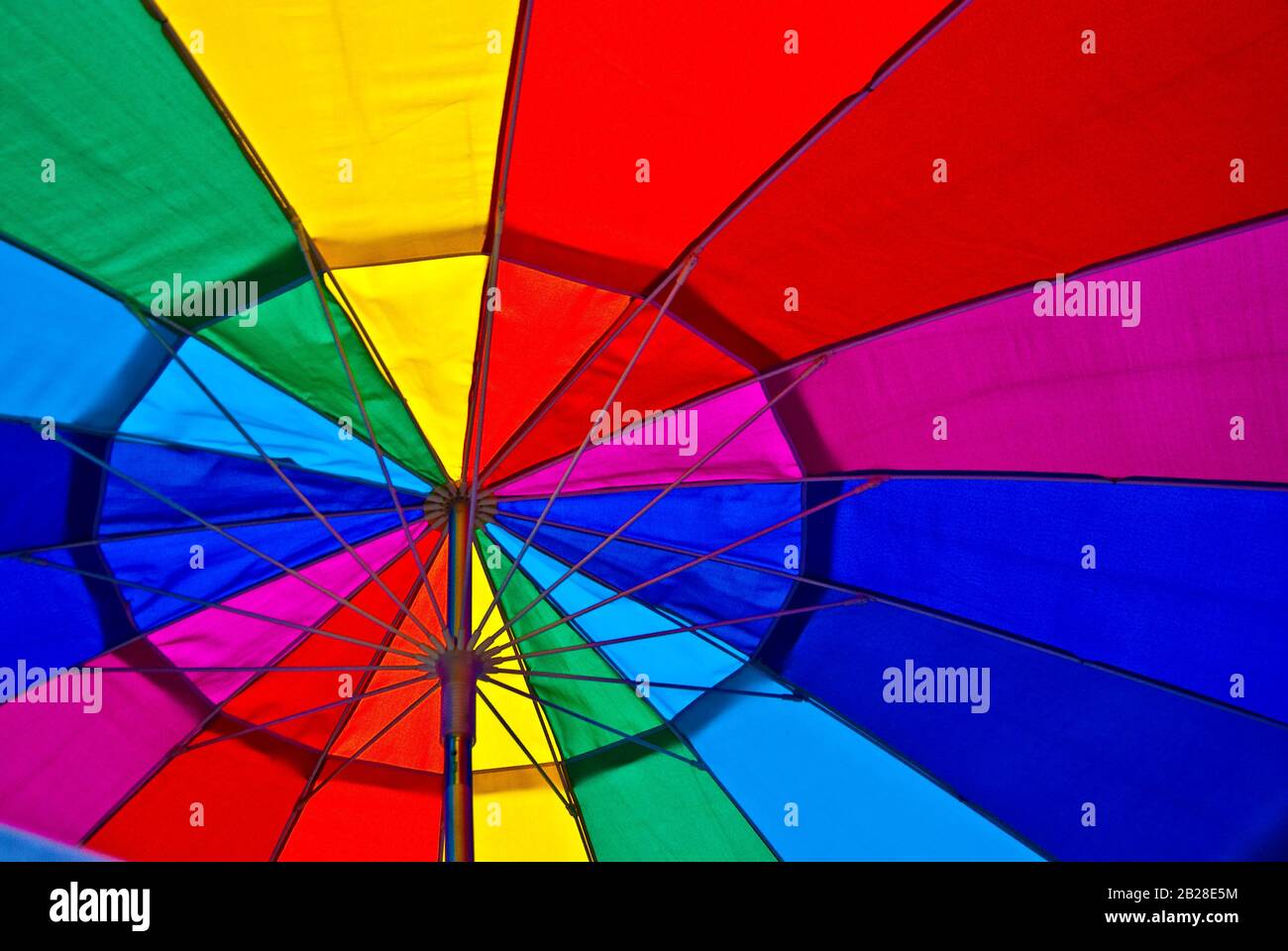Rainbow colored underbelly of an opened umbrella in eight colors on ...