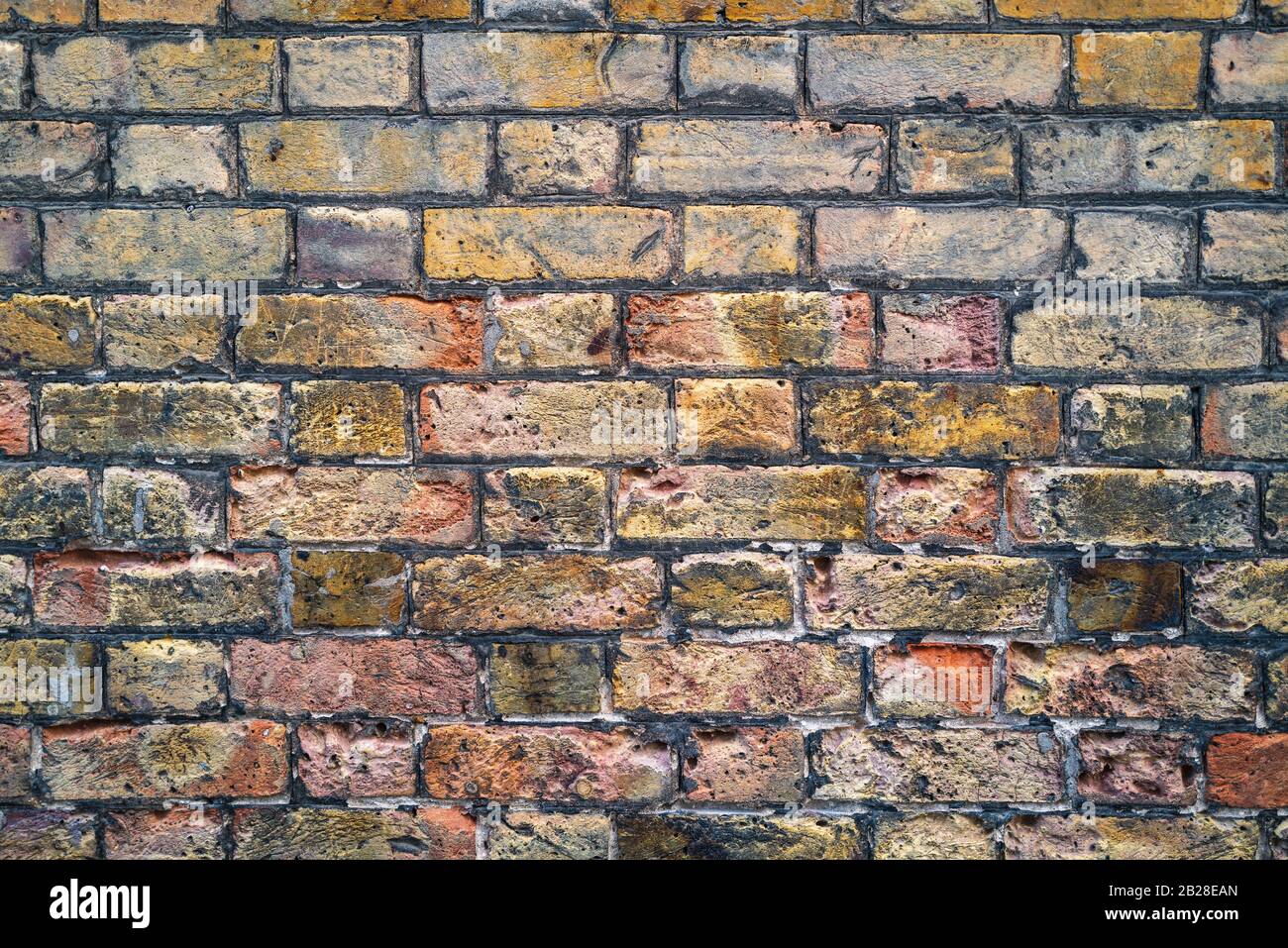 Old brick wall texture with various colours and pit marks in the bricks ...