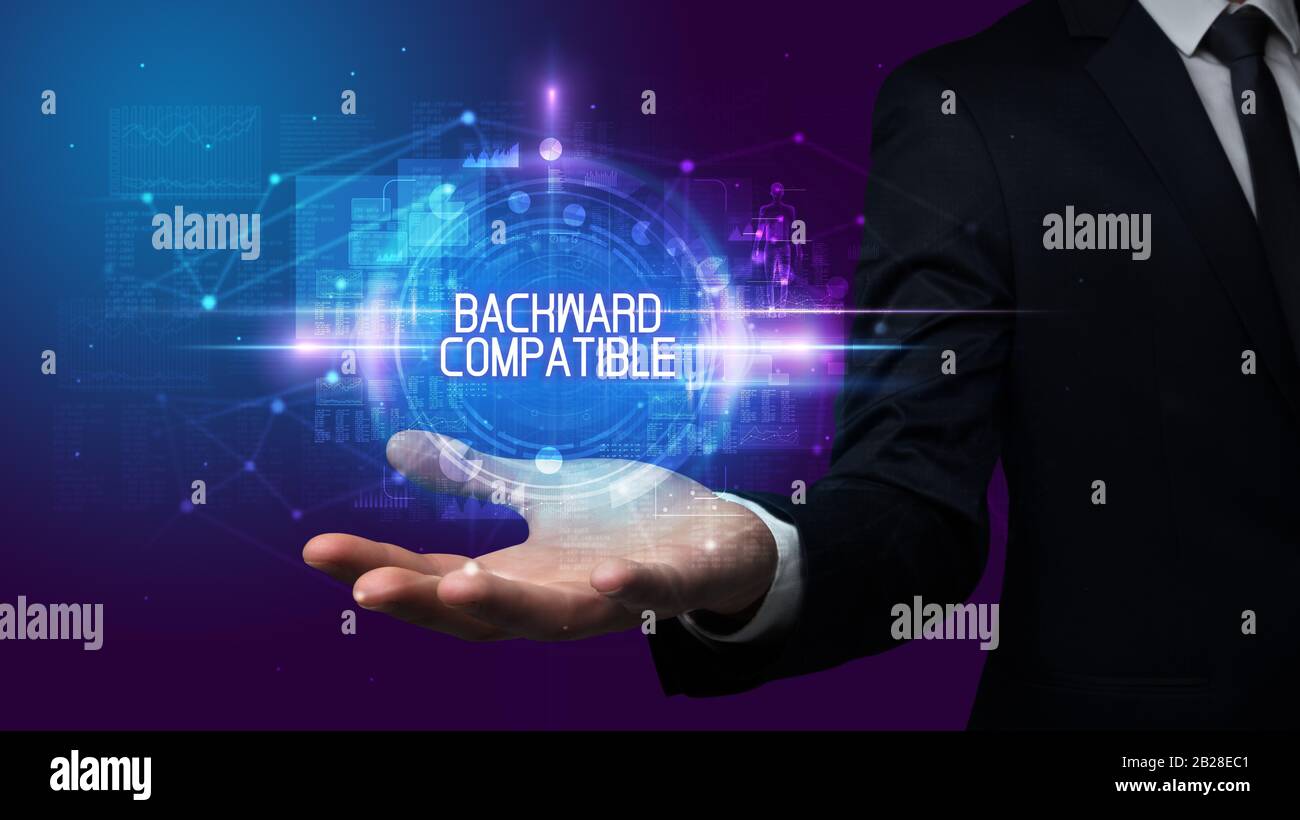 Man hand holding BACKWARD COMPATIBLE inscription, technology concept ...