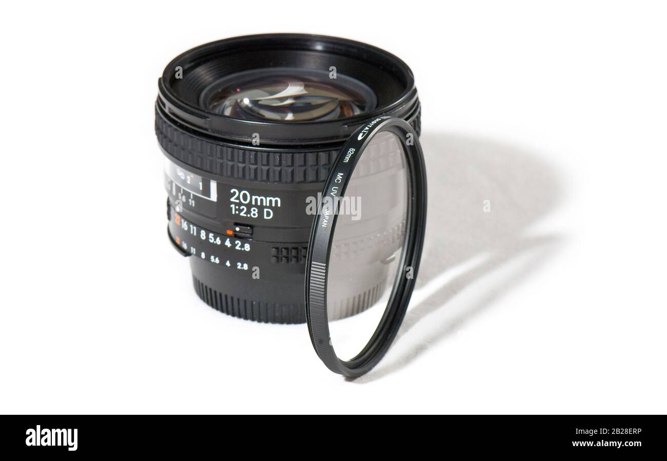 One black 20mm Prime lens with an UV filter leaning near sits against ...
