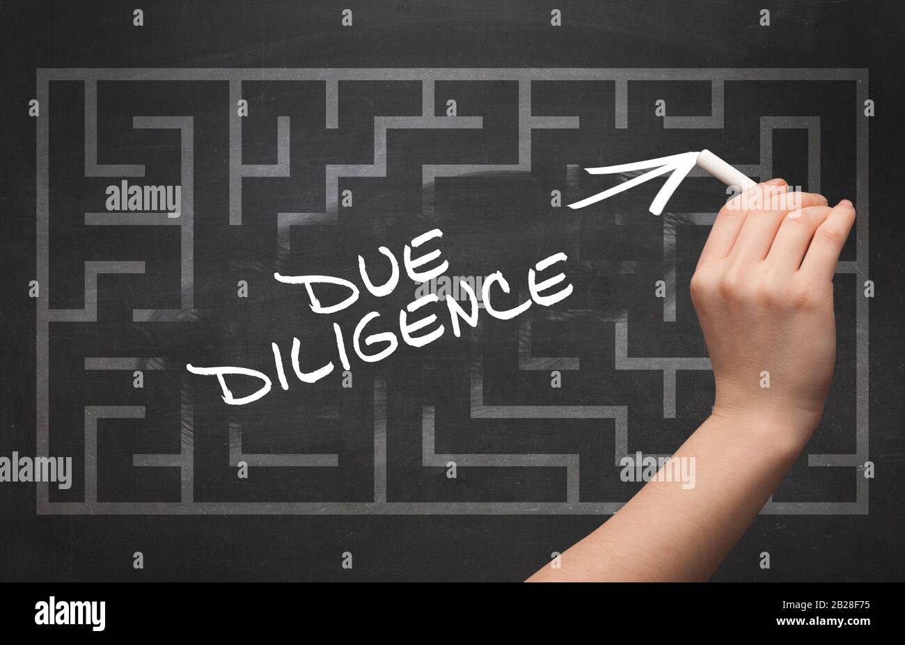 Hand drawing DUE DILIGENCE inscription with white chalk on blackboard ...