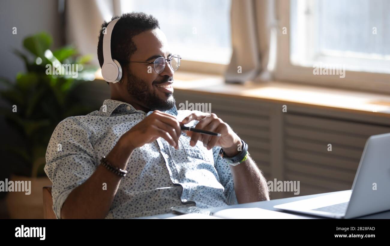 Distracted from job study happy biracial man listening to music Stock ...