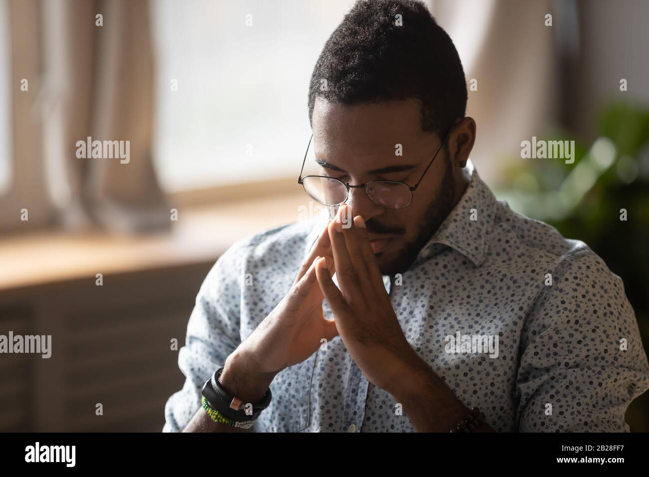 Thoughtful young mixed race man feeling complicated about hard decision ...