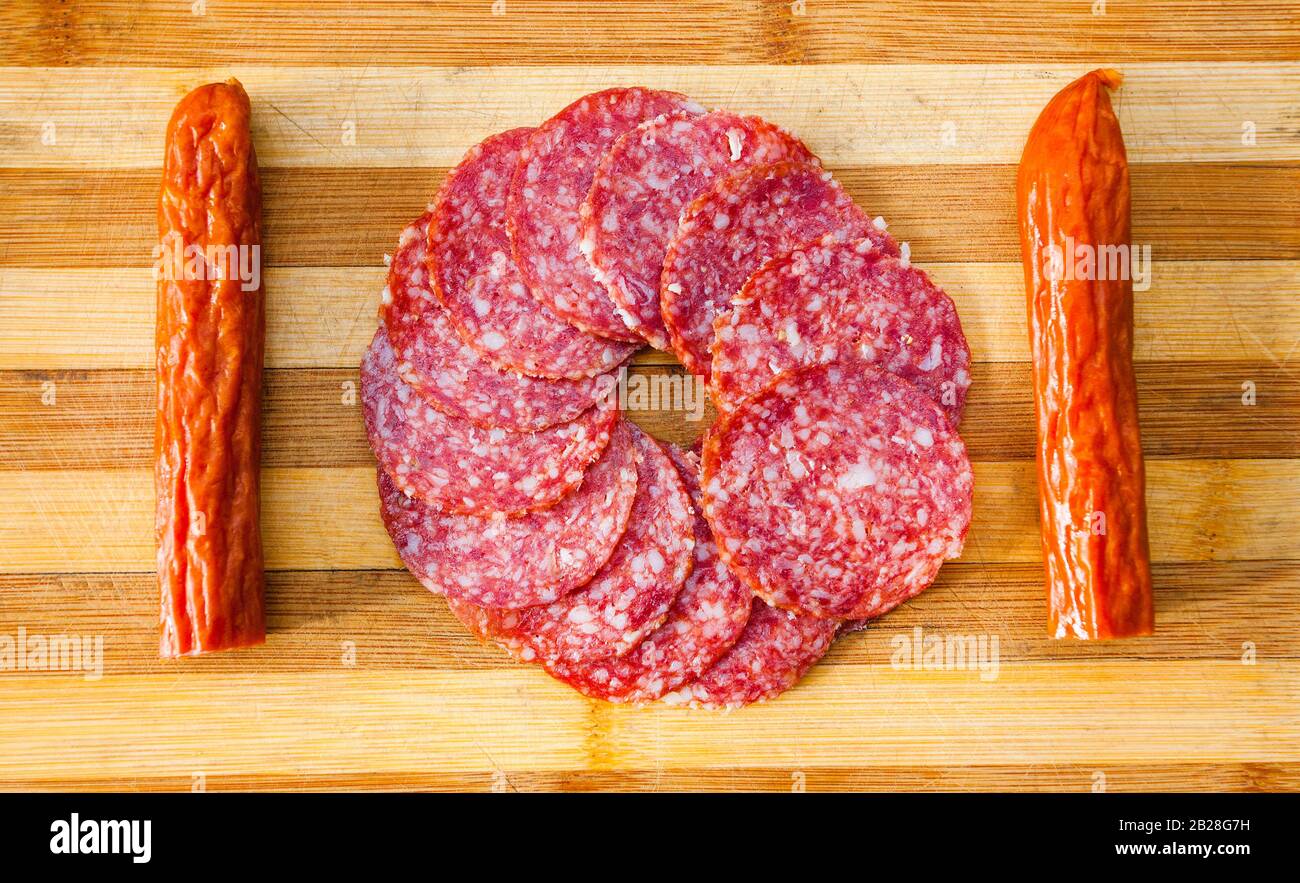 salami with sausage meat slices and frame on cutting board Stock Photo ...