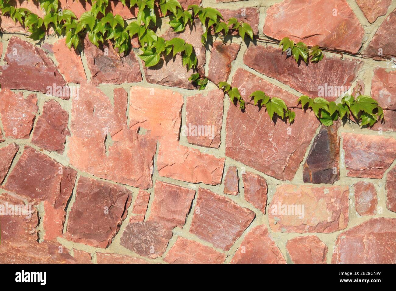 Granite stone wall, background. Pink surface, made of granite rocks ...