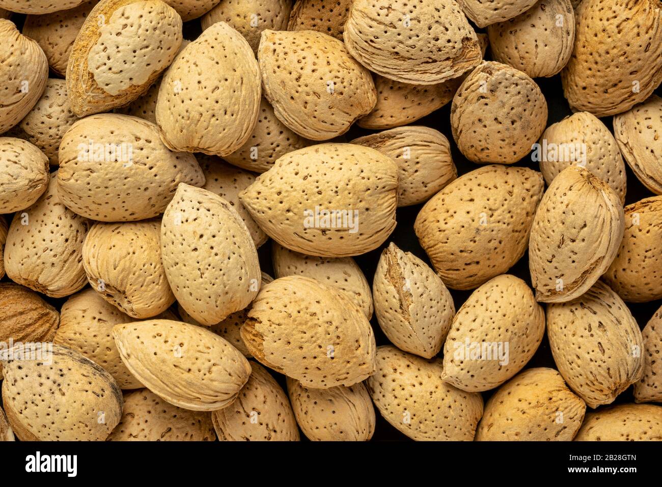 almond nuts in shells - closeup background, superfood concept Stock ...