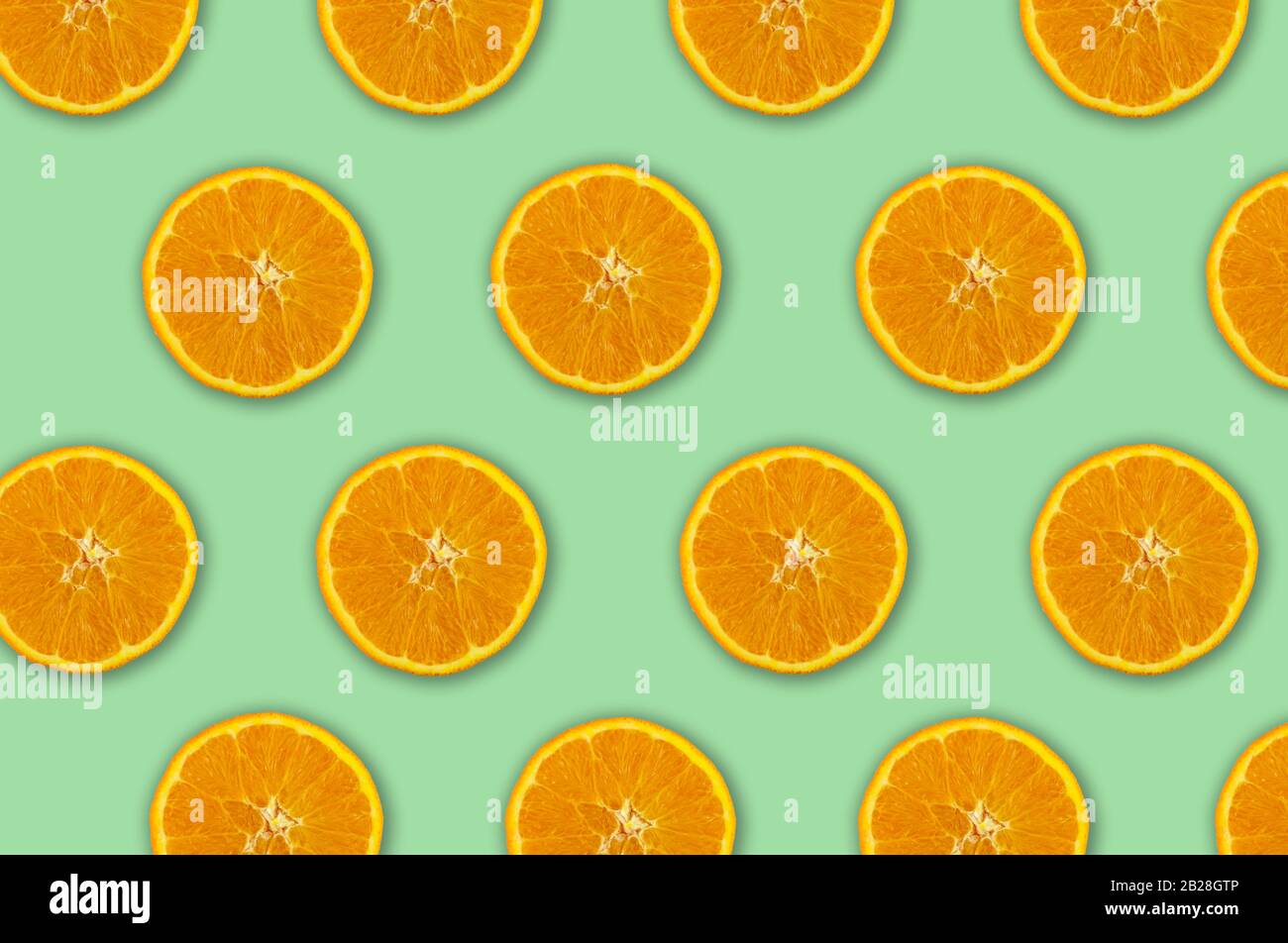 Creative food background. Pattern with fresh orange slices on mint ...