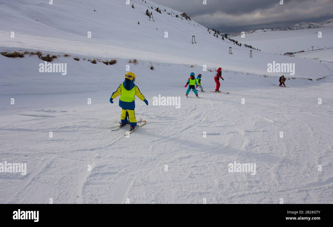 children learning how to ski on mountain slope, winter scene Stock ...