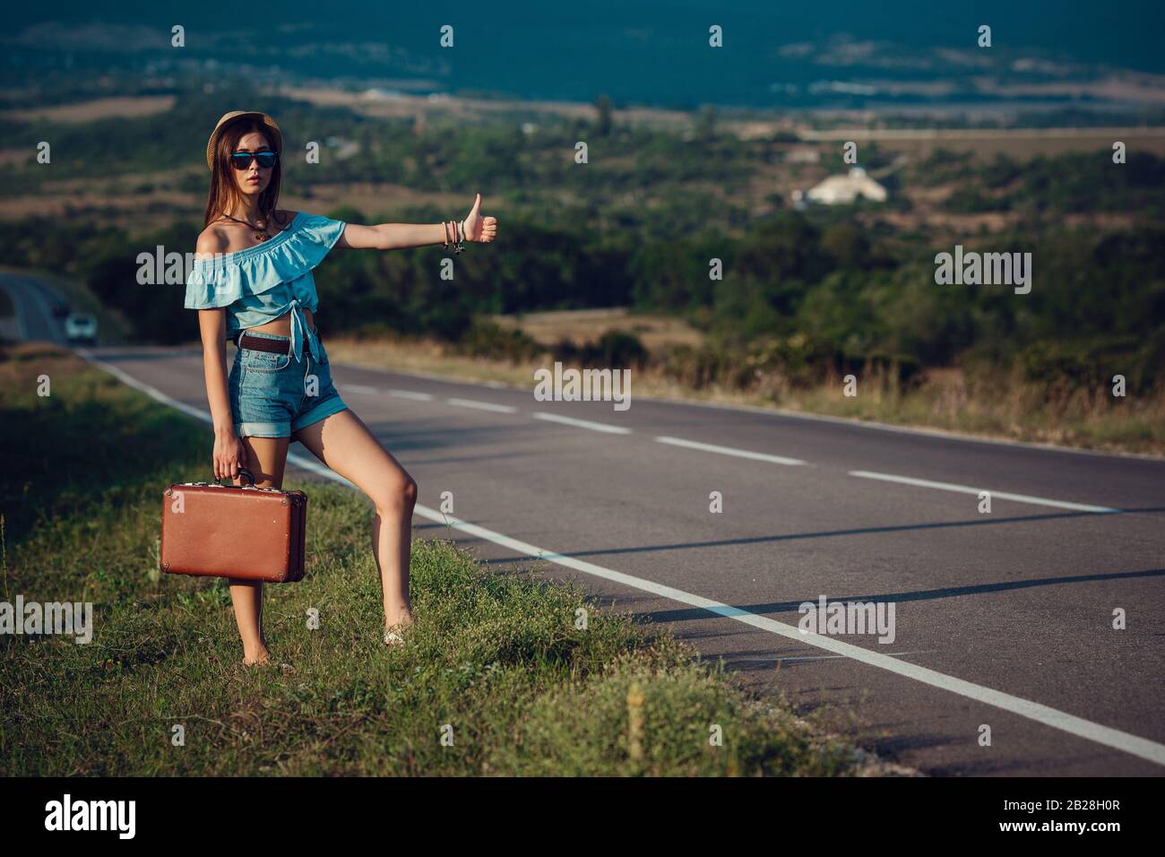 Young beautiful Asian woman in hippy style. travels by hitchhiking ...