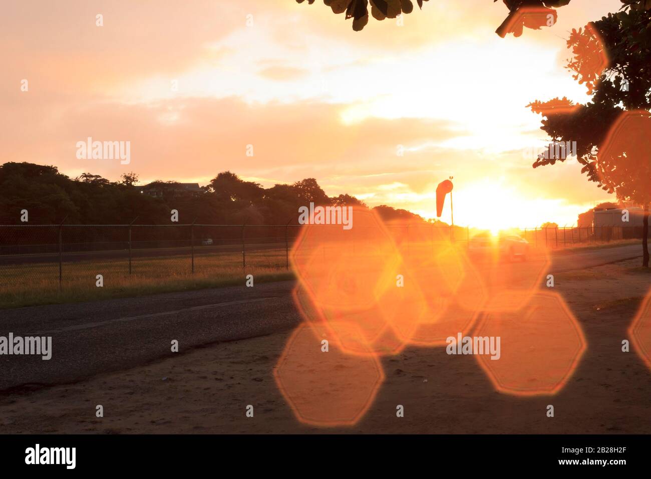 Hexagonal bokeh illuminated bright orange from the rays of sun from a ...