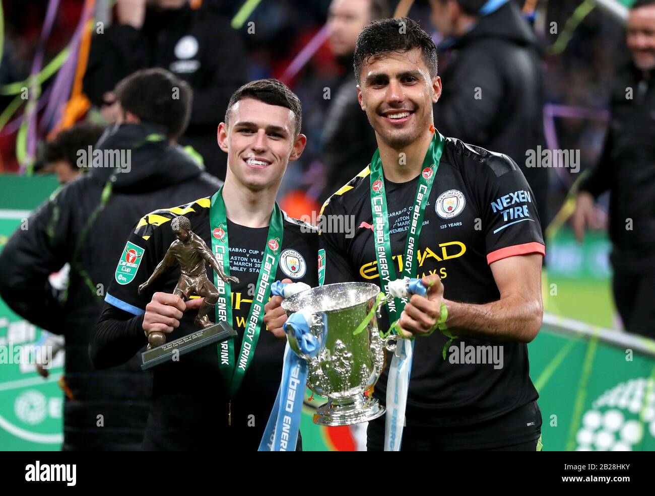 Manchester City's Phil Foden (left) holds his man of the match trophy ...