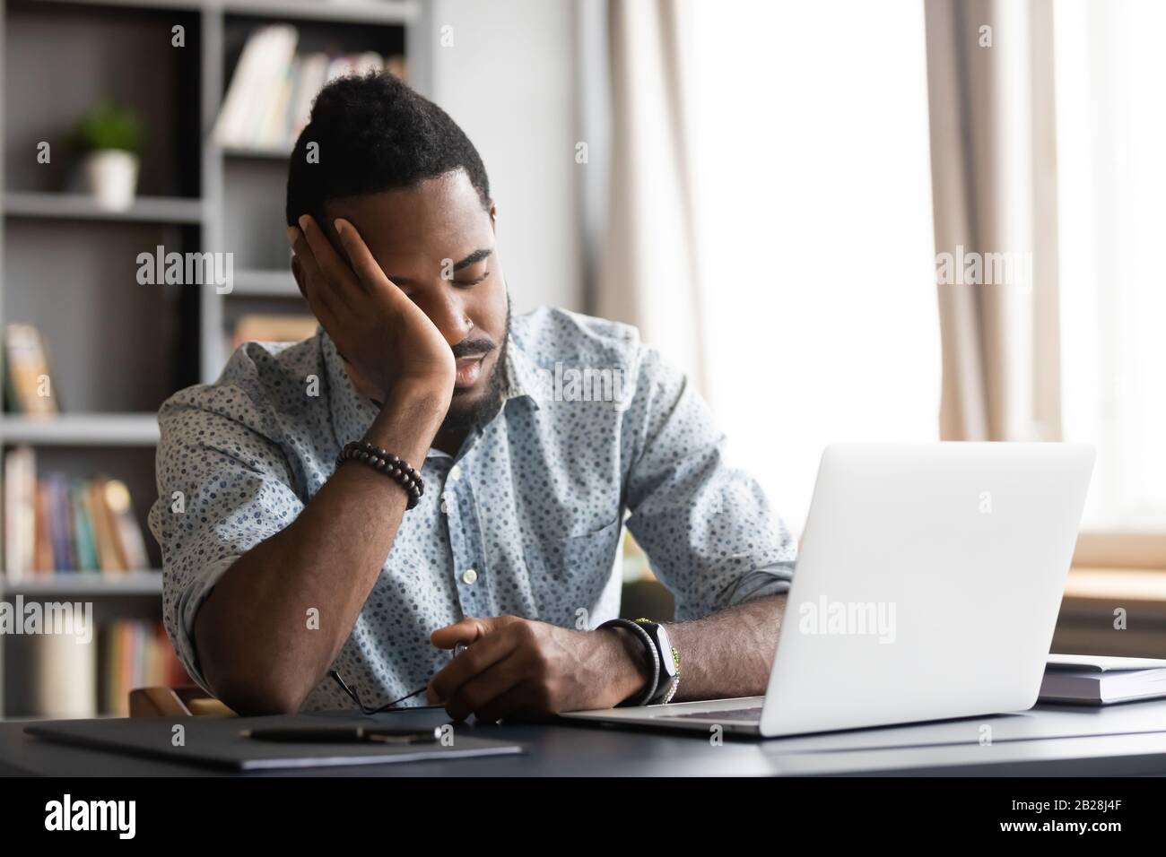 Leaning on hand hi-res stock photography and images - Alamy