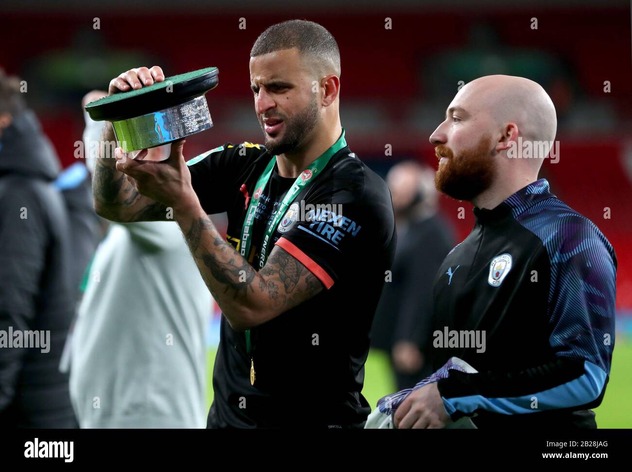 Manchester City's Kyle Walker (left) reads the text engraved on on the ...