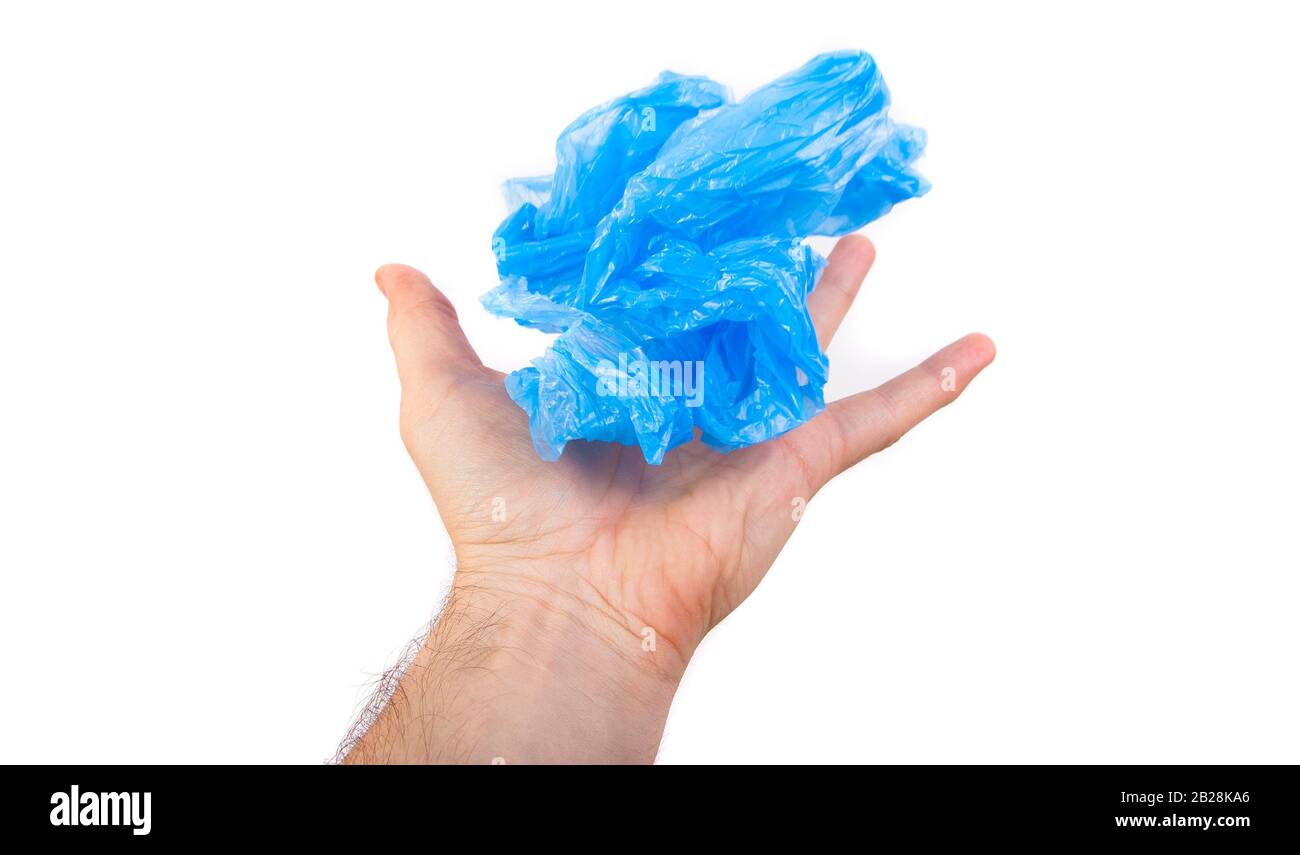 hand holding blue plastic bag isolated on white background. recycle or ...