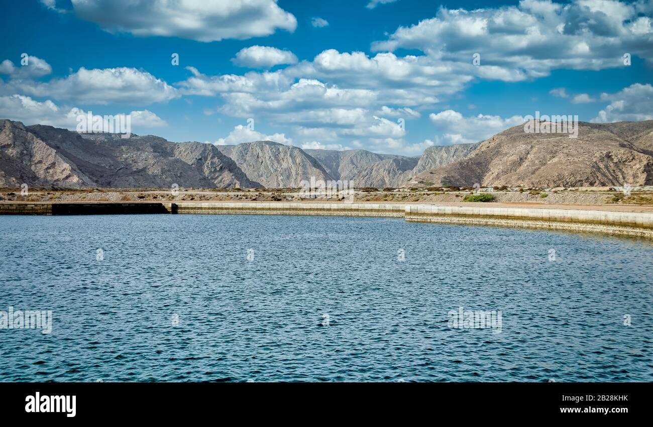 Vast lake at the foot of the hills in Muscat, Oman with beautiful ...