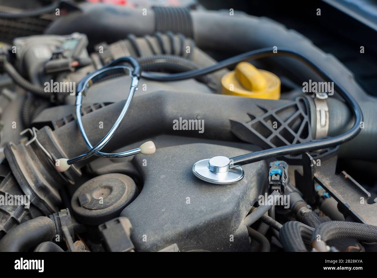 closeup of medical stethoscope on car engine. concept for auto service ...