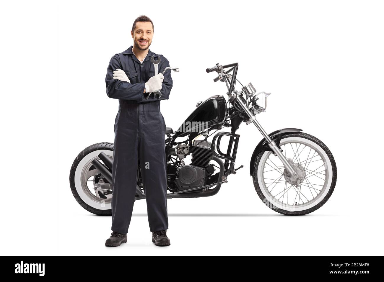 Full length portrait of an auto mechanic standing with a customized ...