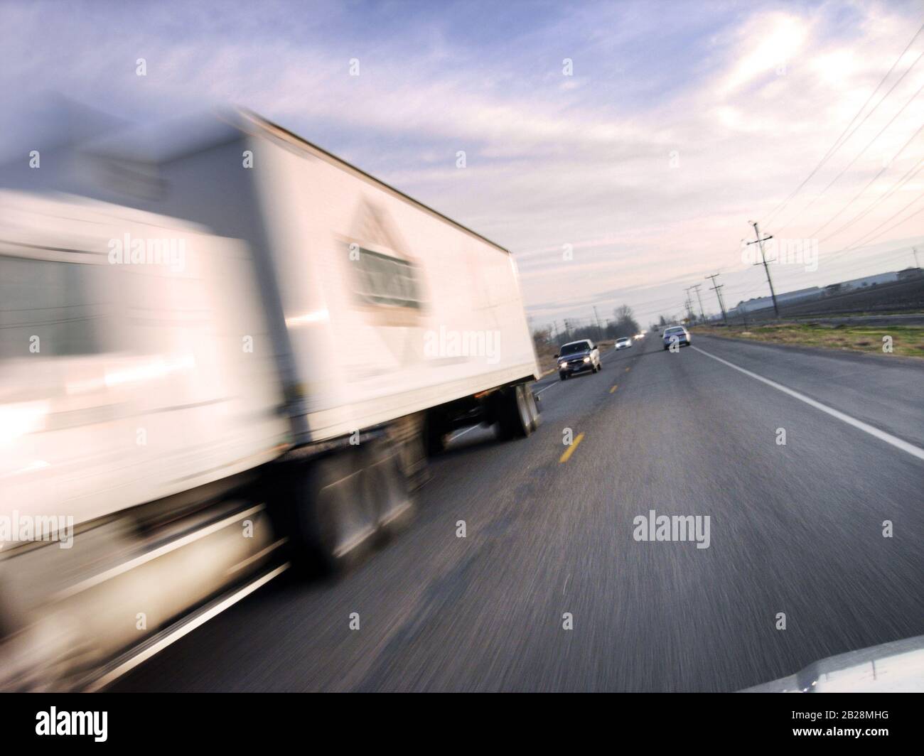 Large truck passing in a blurry motion appearing action while driving ...