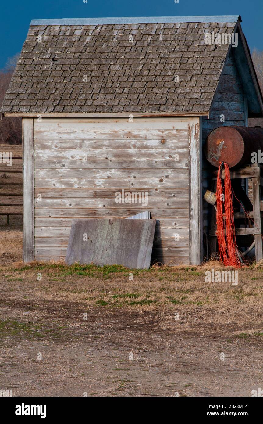 A rusted barrel holds old bailing line near the shady side of a small ...