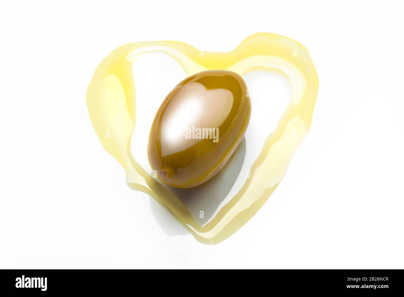 studio photo of olive in heart shaped olive oil with heart shaped ...