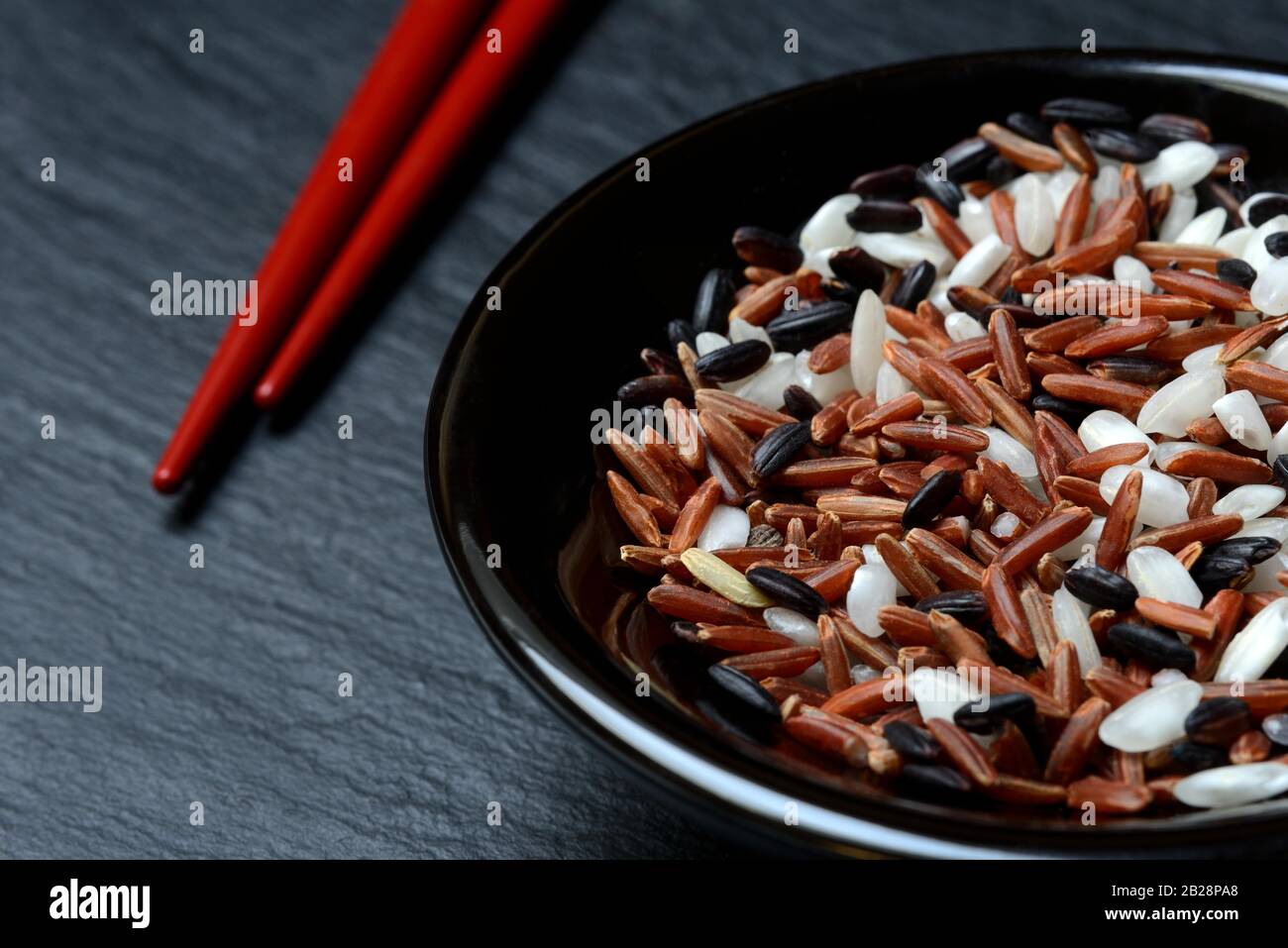 Different kinds of rice in bowls and red chopsticks, Germany Stock ...