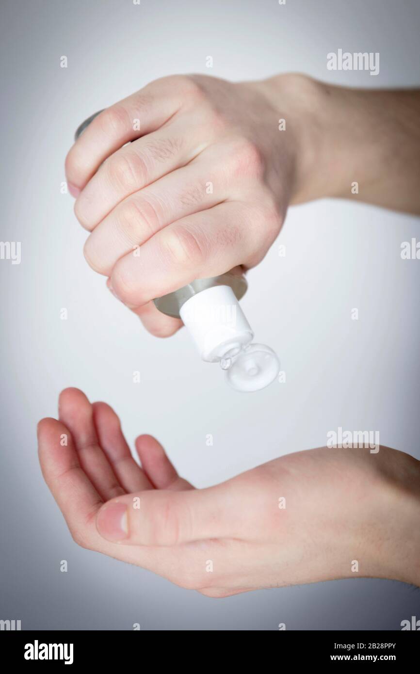 Close-up of someone using alcohol-based hand gel Stock Photo - Alamy
