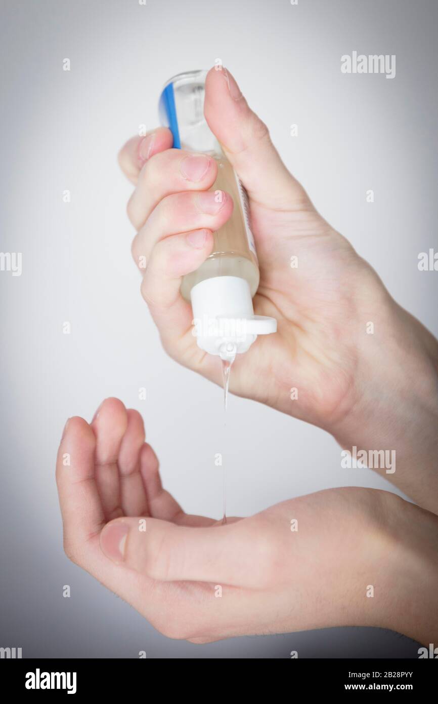 Close-up of someone using alcohol-based hand gel Stock Photo - Alamy