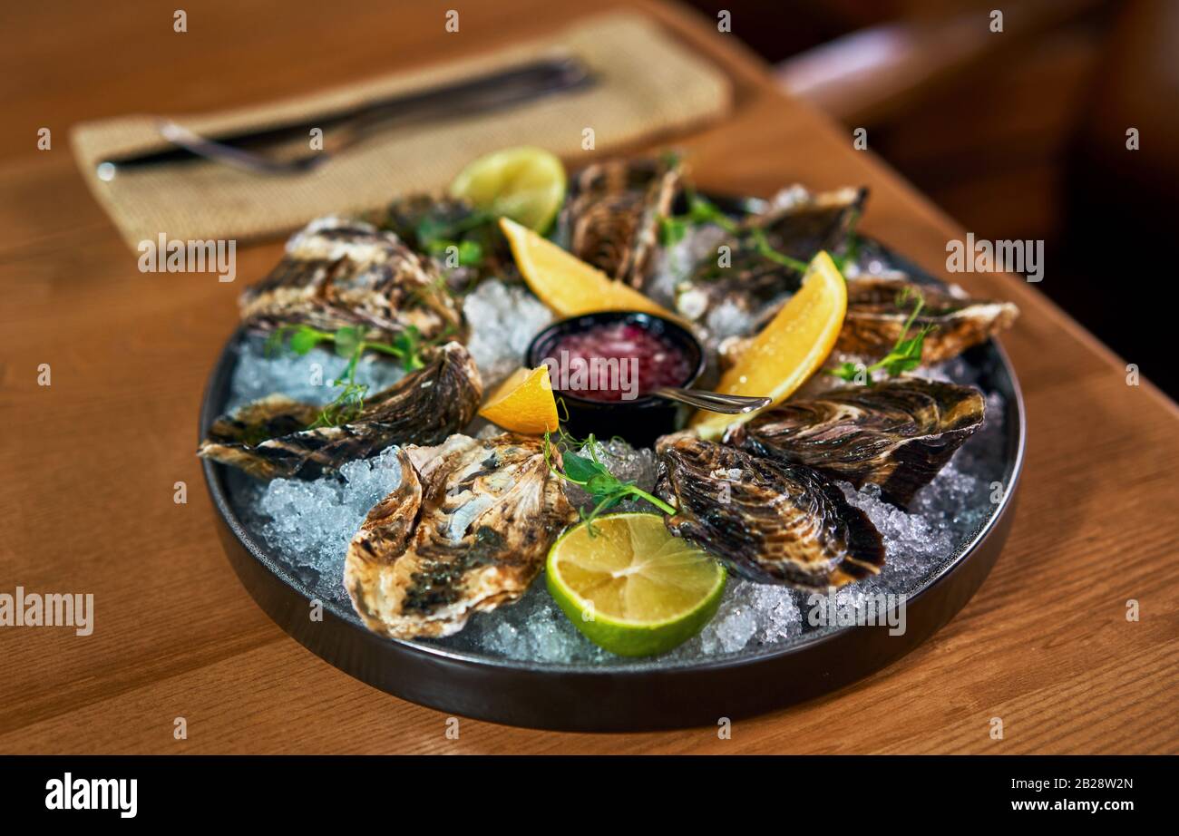 man eating oysters at the table Stock Photo - Alamy