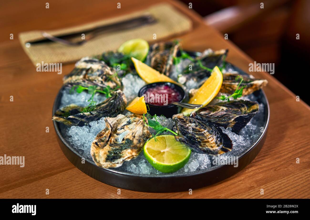man eating oysters at the table Stock Photo - Alamy